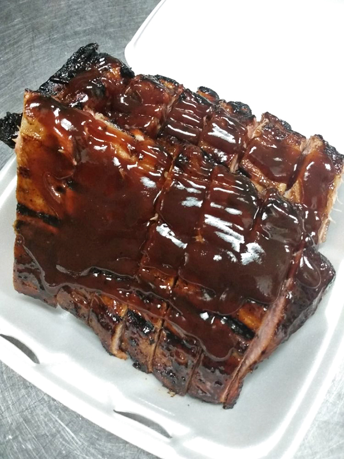 Ribs glazed with sauce that would make even vegetarians pause for a moment of reflection. That smoke ring is the barbecue equivalent of a Rolex.