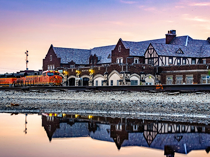 The historic Newton train depot glows at sunset, a Tudor-style reminder of when the Santa Fe Railroad put this town on the map.