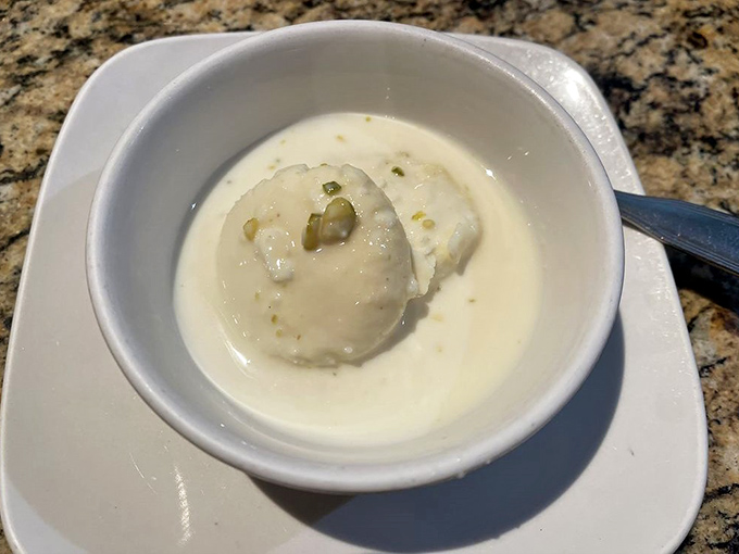 Ras Malai—the dessert equivalent of floating on a cloud. This delicate cheese dumpling swimming in sweetened milk makes ice cream seem unimaginative.