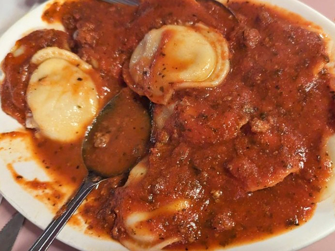 Ravioli swimming in a sea of homemade sauce. Pasta pillows that make you want to rest your fork here indefinitely.