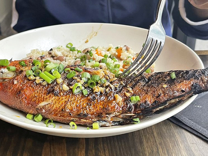 A whole fish that stares back at you with pride. Crispy-skinned and garnished with scallions, it's a testament to simple preparation done right.