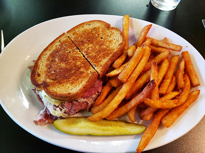 The Reuben sandwich&mdash;perfectly grilled rye embracing corned beef, sauerkraut, and Swiss in a harmonious dance. A masterclass in sandwich architecture.
