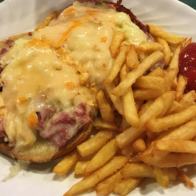 A Reuben sandwich that doesn't mess around &ndash; melted cheese cascading over corned beef like it's auditioning for a food commercial.