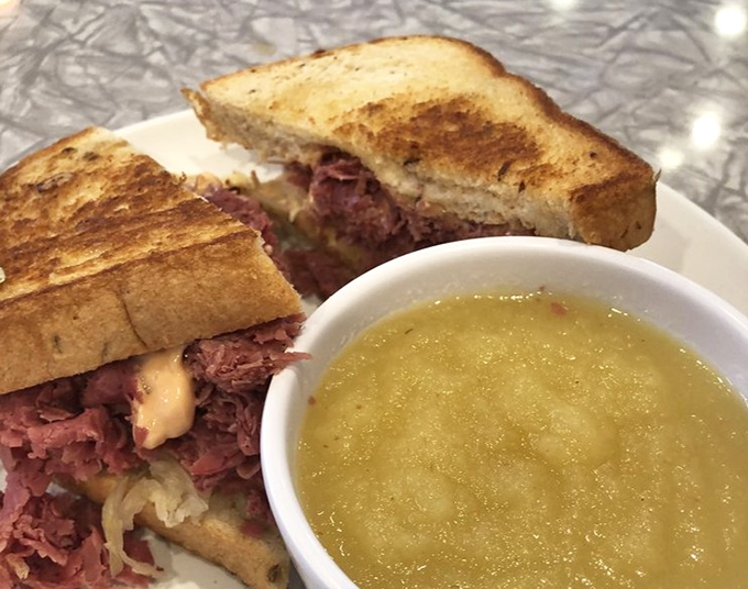 The Reuben&mdash;where corned beef meets sauerkraut in a dance as old as time, with a side of applesauce playing chaperone.