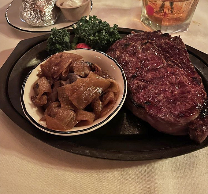 This rib eye arrives with perfectly saut&eacute;ed mushrooms, proving Pinewood understands the sacred bond between steak and fungi.