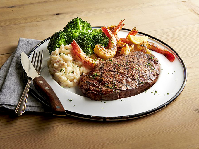 Surf meets turf in perfect harmony: a perfectly seared steak shares the plate with succulent shrimp, creamy risotto, and vibrant broccoli.