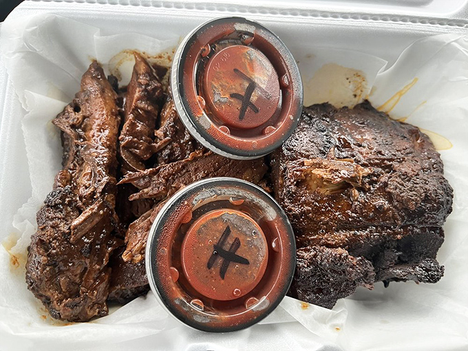 Ribs so dark and glistening they look like they've been sunbathing in smoke, with sauce cups marked with an "H" &ndash; "H" clearly standing for "Heavenly."