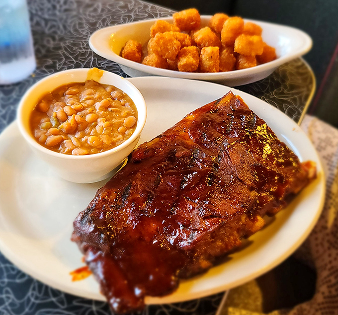 Glistening ribs with that perfect smoke ring, flanked by baked beans and tater tots&mdash;a trio that makes carnivores weak at the knees.