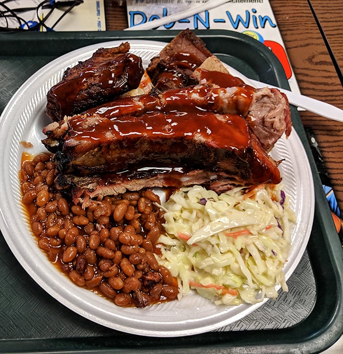 Ribs glistening with sauce, flanked by creamy coleslaw and beans that mean business. This plate doesn't just feed you—it hugs your soul.