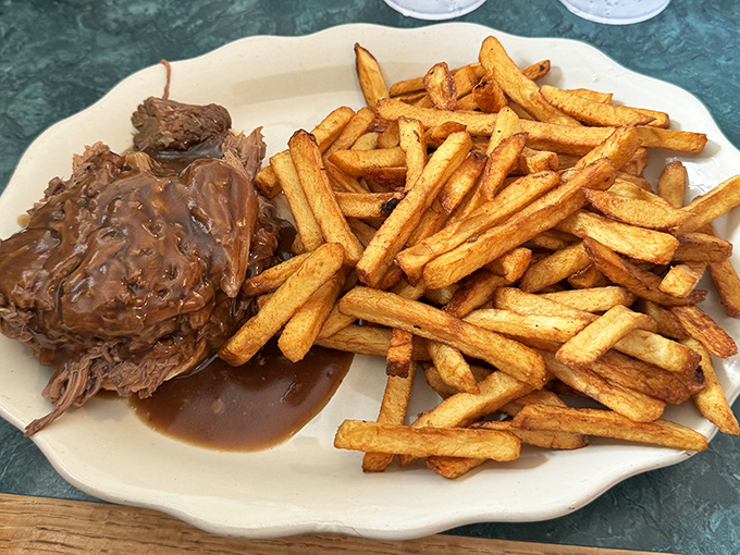 Tender roast beef swimming in gravy alongside golden fries&mdash;proof that sometimes the simplest pleasures are the most profound.