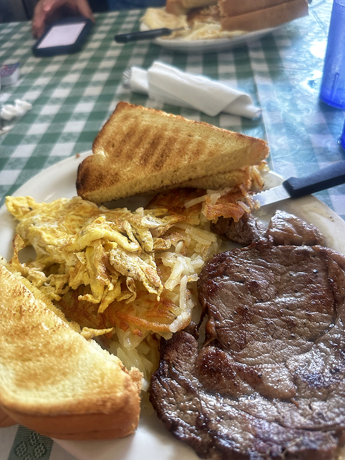 The ultimate breakfast trinity: perfectly toasted bread, eggs scrambled just right, and a steak that means business.