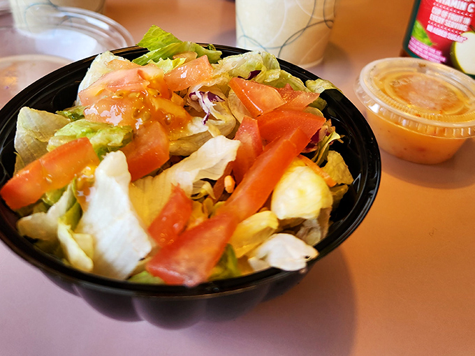 Even the salad shows up ready to play its supporting role&mdash;fresh, colorful, and waiting patiently while you eye that pizza.