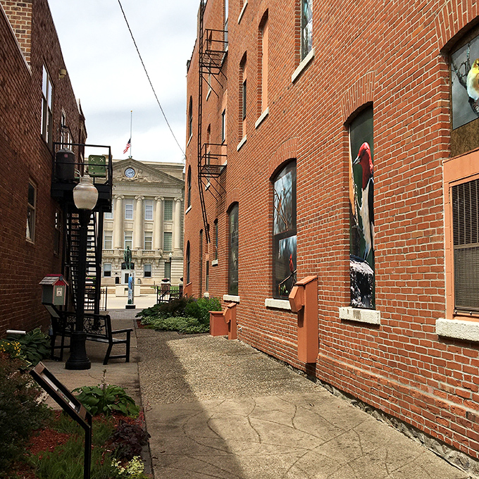 Brick-lined alleys reveal Jefferson's hidden charms, where history peeks around corners and the courthouse stands sentinel in the distance.