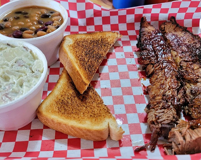 Bean perfection meets meat excellence. The holy trinity of barbecue: great protein, perfect sides, and bread to soak up every last drop.