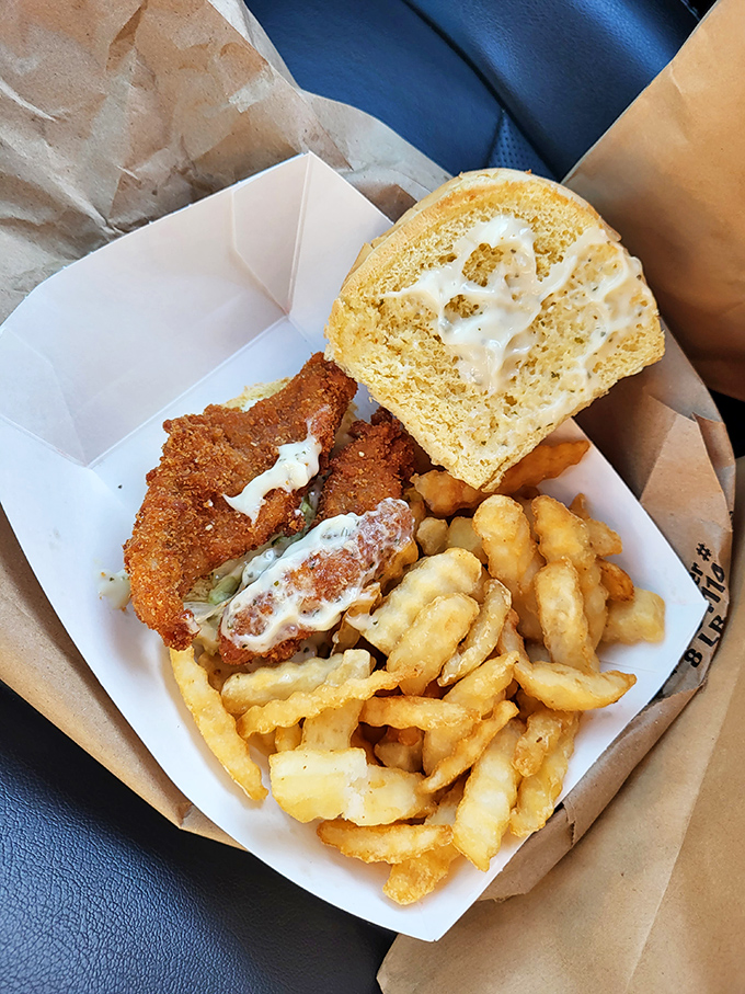 The sandwich that launched a thousand napkins. Crispy chicken, crinkle-cut fries, and a dinner roll that's living its best buttery life.