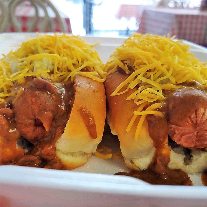 Chili dogs crowned with vibrant yellow cheese&mdash;proof that sometimes the most satisfying culinary experiences come without fancy plating or pretentious descriptions.