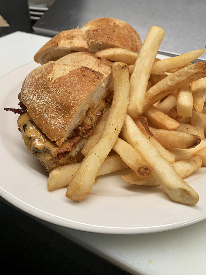 A sandwich that means business—golden fries standing at attention beside a creation that's clearly not just another lunch option.