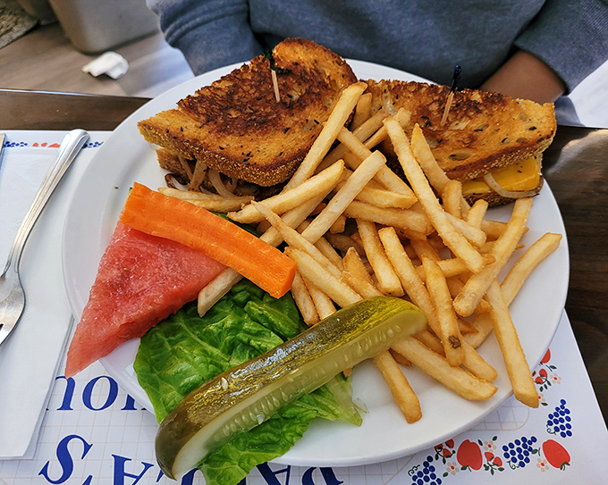 That sandwich towers with melted cheese and comes with a mountain of fries &ndash; clearly, moderation isn't in their vocabulary here.