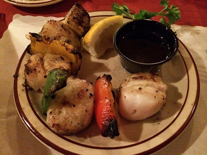 Grilled scallops that would make Neptune himself jealous, kissed by oak smoke and paired with a dipping sauce worth bottling and taking home.
