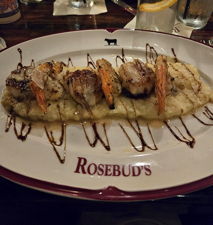 Shrimp perched atop creamy risotto like culinary royalty. The artful balsamic drizzle isn't just decoration&mdash;it's the perfect finishing touch.