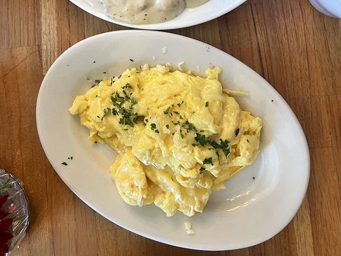 These aren't your average scrambled eggs&mdash;they're cloud-like perfection topped with fresh herbs and a sprinkle of cheese.