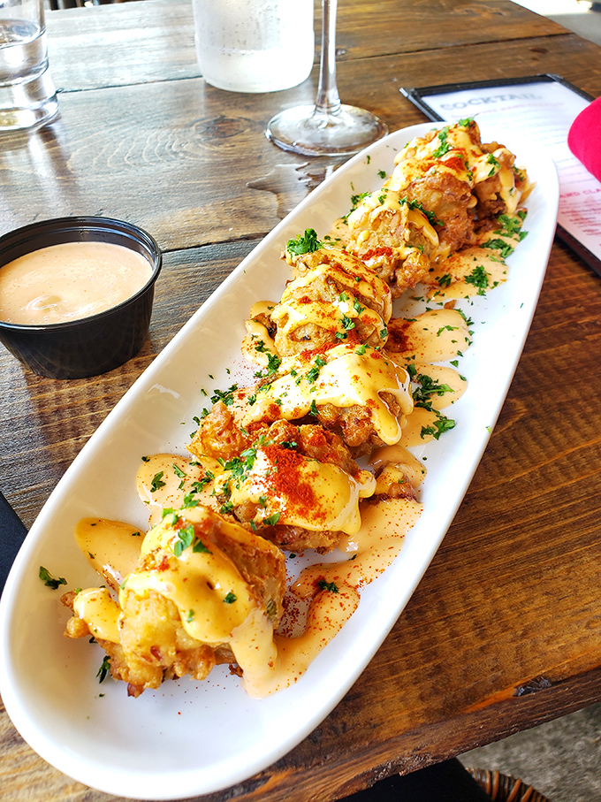 These seafood fritters aren't just appetizers&mdash;they're edible exclamation points. The sauce alongside whispers, "Go ahead, dip me. You know you want to."