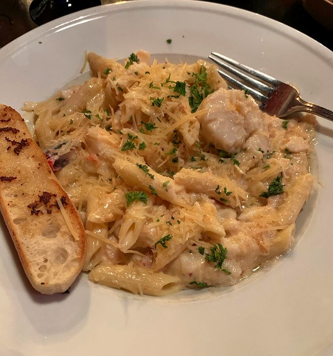 Creamy seafood penne pasta studded with shrimp and garlic bread that's basically asking to be devoured immediately.