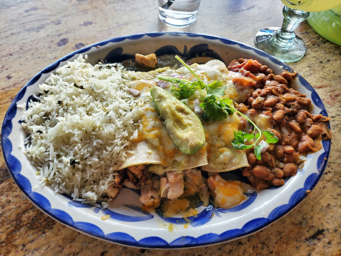 A plate that tells a story&mdash;rice, beans, and enchiladas creating a colorful trilogy of flavors that would make any abuela proud.