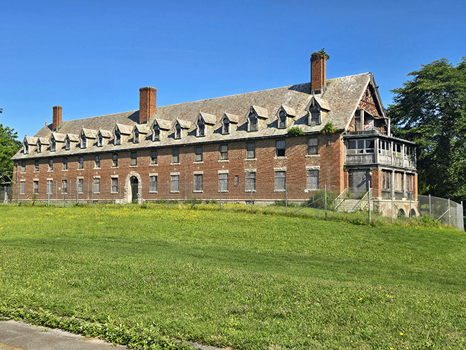 The imposing Seaside Sanatorium whispers stories of the past while standing sentinel over grassy lawns and distant shores.