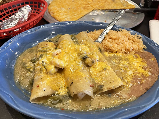 Green sauce enchiladas that make you question why you ever settled for the red version. The cheese pull alone deserves its own Instagram account.