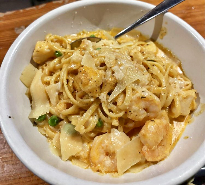 Silky ribbons of pasta cradle plump shrimp like edible love letters from the Pacific Northwest.