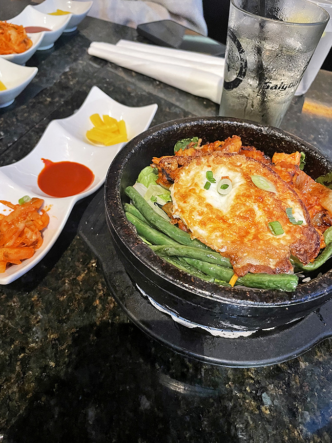 The sizzling Saigon steak arrives still singing its crackling song, nestled among green beans and topped with a perfect sunny-side-up egg.