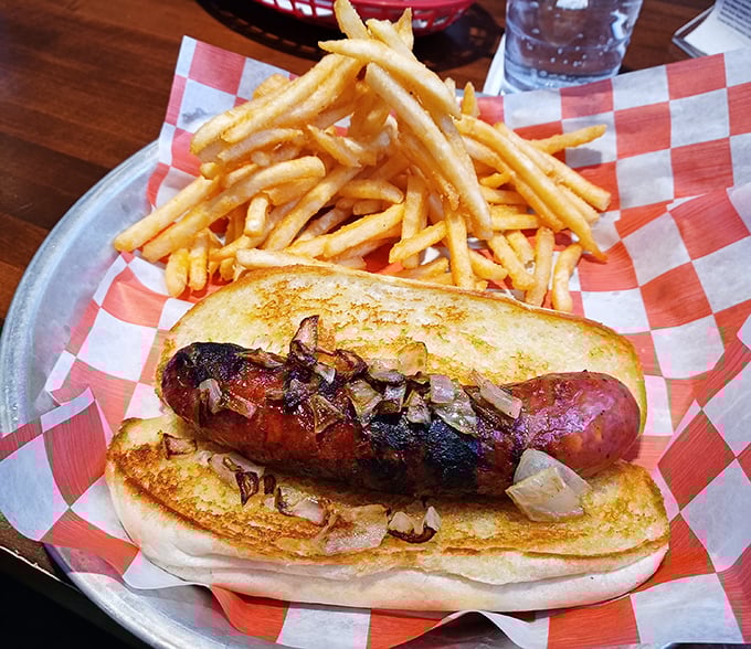 A sausage that's lived its best life, nestled in a toasted bun with caramelized onions. Paired with golden fries, it's comfort food elevated to an art form.
