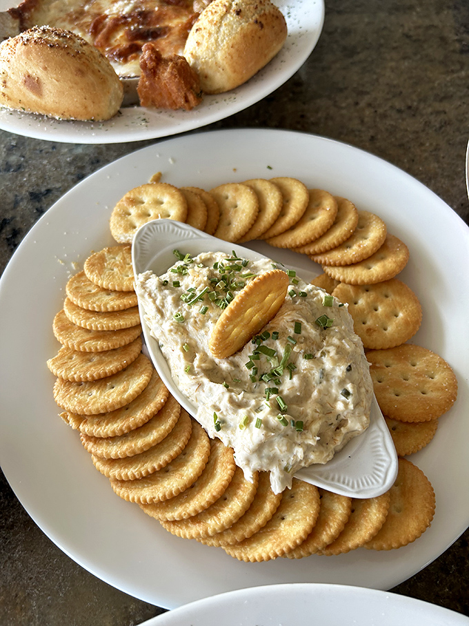 The smoked tuna dip surrounded by crackers isn't just an appetizer—it's the beginning of a beautiful friendship between your taste buds and the Gulf.