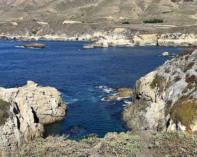 The blue-on-blue vista where ocean meets sky in perfect harmony. This is the kind of view that makes smartphone cameras weep with inadequacy.
