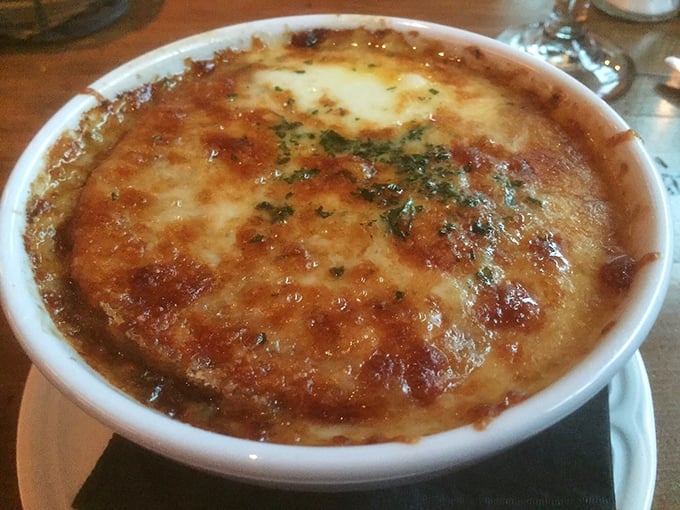 This isn't just French onion soup—it's a bubbling cauldron of comfort topped with a golden cheese canopy.