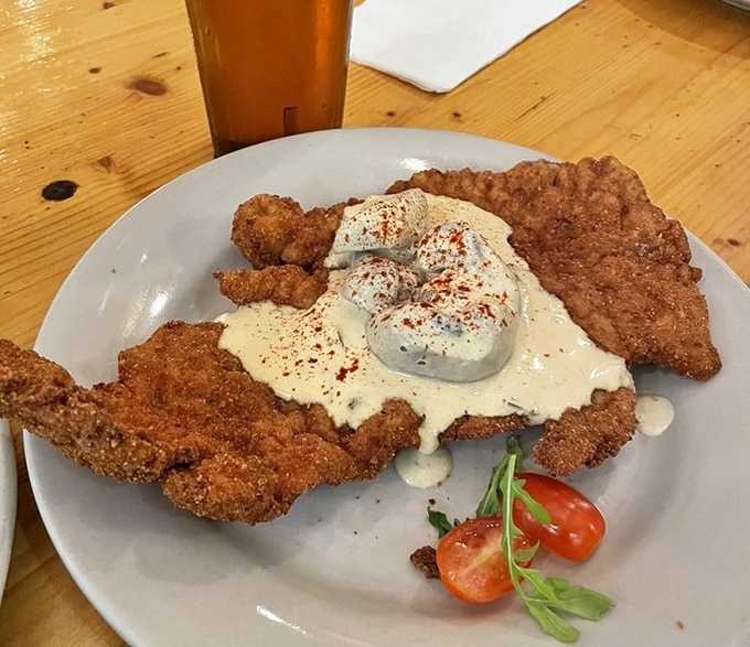Not your average schnitzel! This beauty wears a dollop of sour cream like a crown &ndash; royalty on a plate.