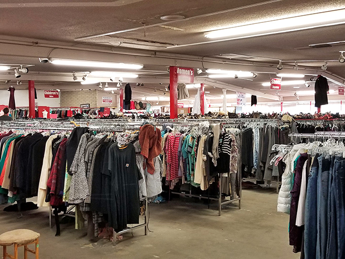 The thrifter's paradise stretches as far as the eye can see, with color-coded racks creating a rainbow road to bargain heaven.