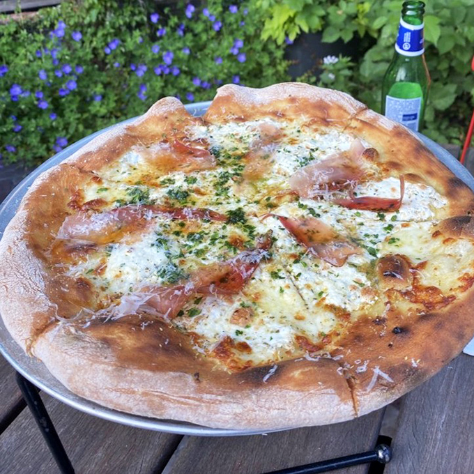 The Speck Pie is what happens when pizza gets dressed up for a fancy night out&mdash;prosciutto, herbs, and that pillowy-yet-crisp crust stealing the show.