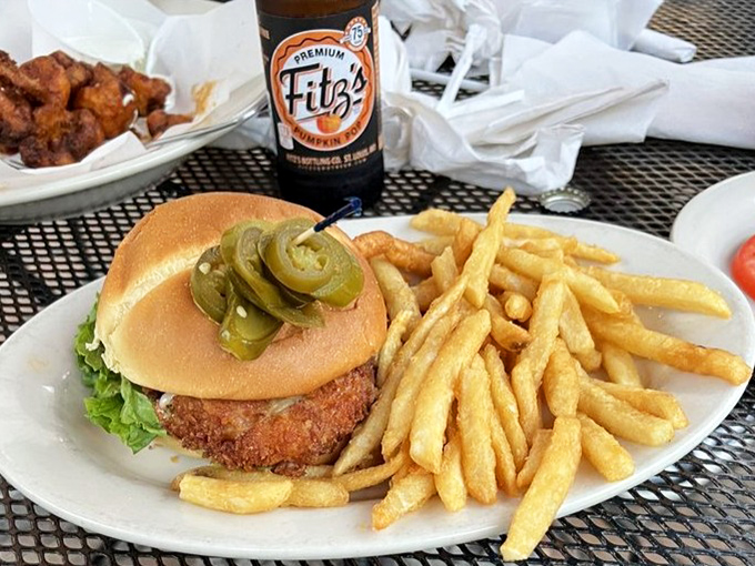 Jalape&ntilde;os perched atop this burger like tiny green sentinels guarding flavor territory. The pickle spears are just showing off at this point.