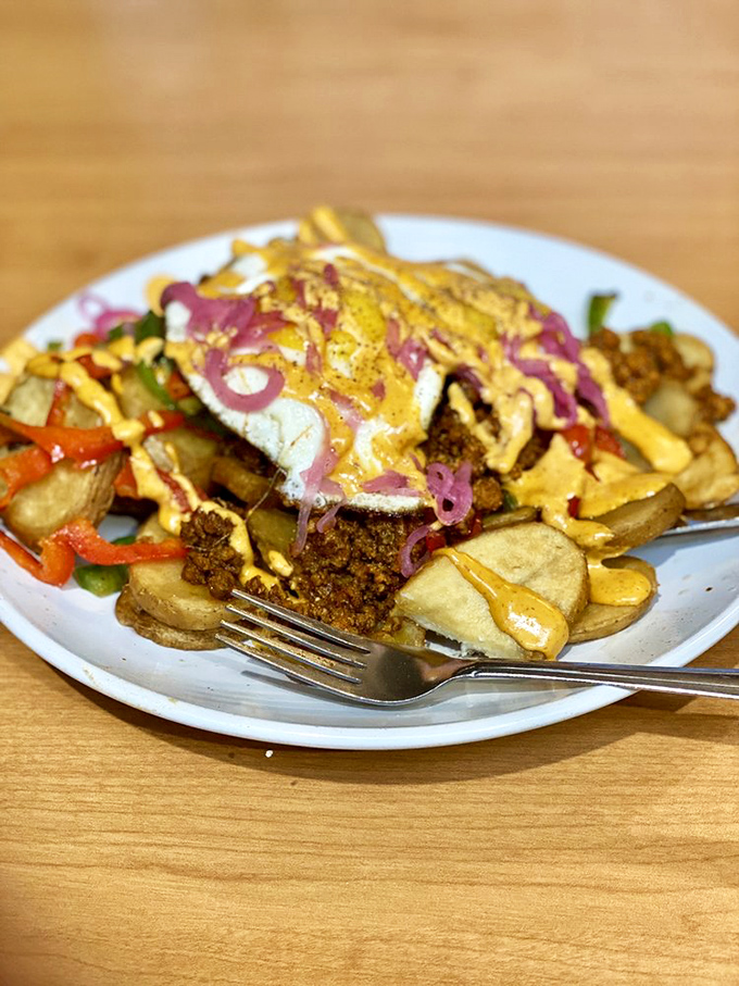 This loaded hash creation looks like what would happen if breakfast and dinner had a beautiful baby &ndash; topped with a sunny egg and vibrant pickled onions.