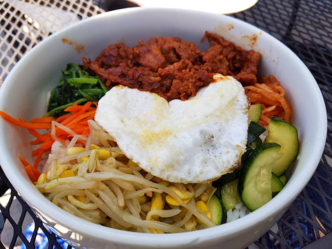 Bibimbap that makes your taste buds do the happy dance. That heart-shaped egg is sending a not-so-subtle message: true love is found in Korean comfort food.