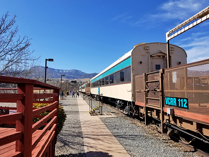 All aboard! The boarding platform offers the first hint of the journey ahead, with mountains standing sentinel in the distance.