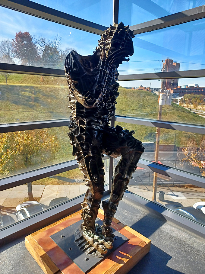 A haunting figure sculpted from what appears to be metal scraps stands sentinel by the windows. With Baltimore's skyline as backdrop, it's a powerful meditation on humanity and industry.