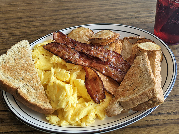 The breakfast plate that launched a thousand satisfied sighs&mdash;scrambled eggs, crispy bacon, and toast ready for its butter close-up.