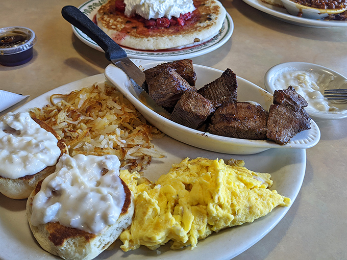 The breakfast of champions: biscuits smothered in creamy gravy, scrambled eggs, and steak tips. Your cardiologist won't approve, but your soul will.