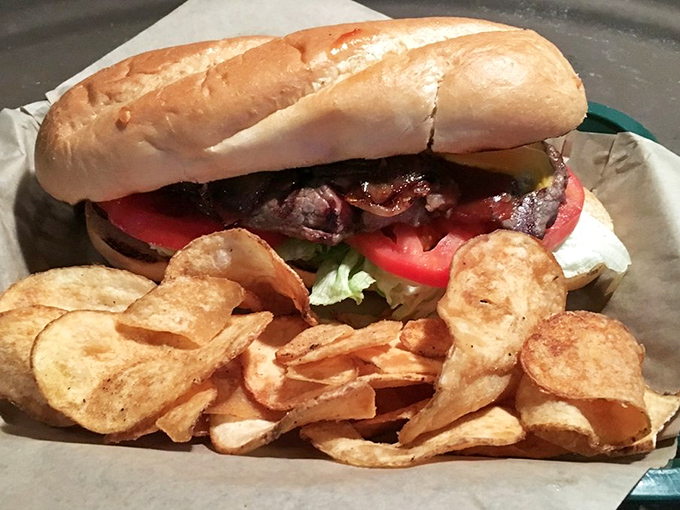 When a sandwich requires this much structural integrity, you know you're in for something special. The pickle adds just enough tang to cut through the richness.