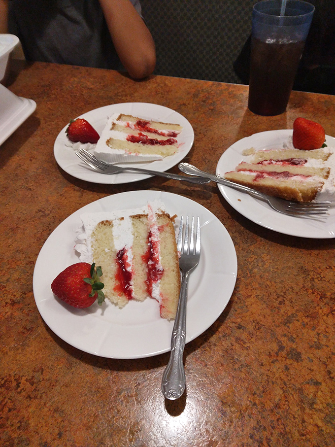 Three slices of strawberry shortcake that prove the bakery part of "Diner & Bakery" isn't just an afterthought—it's a destination in itself.