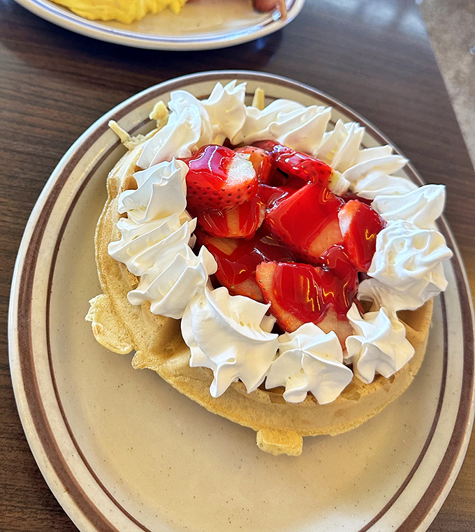 Strawberry waffles that look like they're dressed for a special occasion&mdash;whipped cream corsage, berry boutonni&egrave;re, and ready to dance with your taste buds.