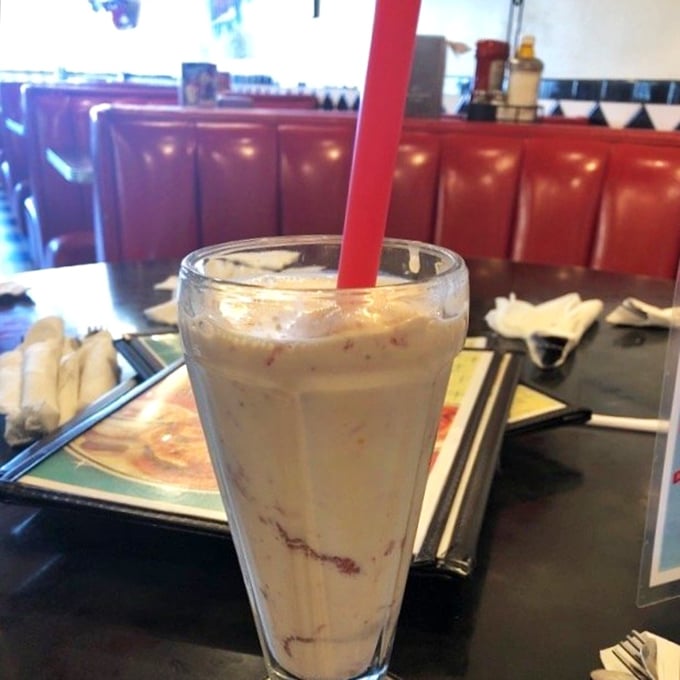 This isn't just a milkshake&mdash;it's a commitment. That red straw stands ready for the delicious challenge ahead, while those swirls promise strawberry bliss in every sip.